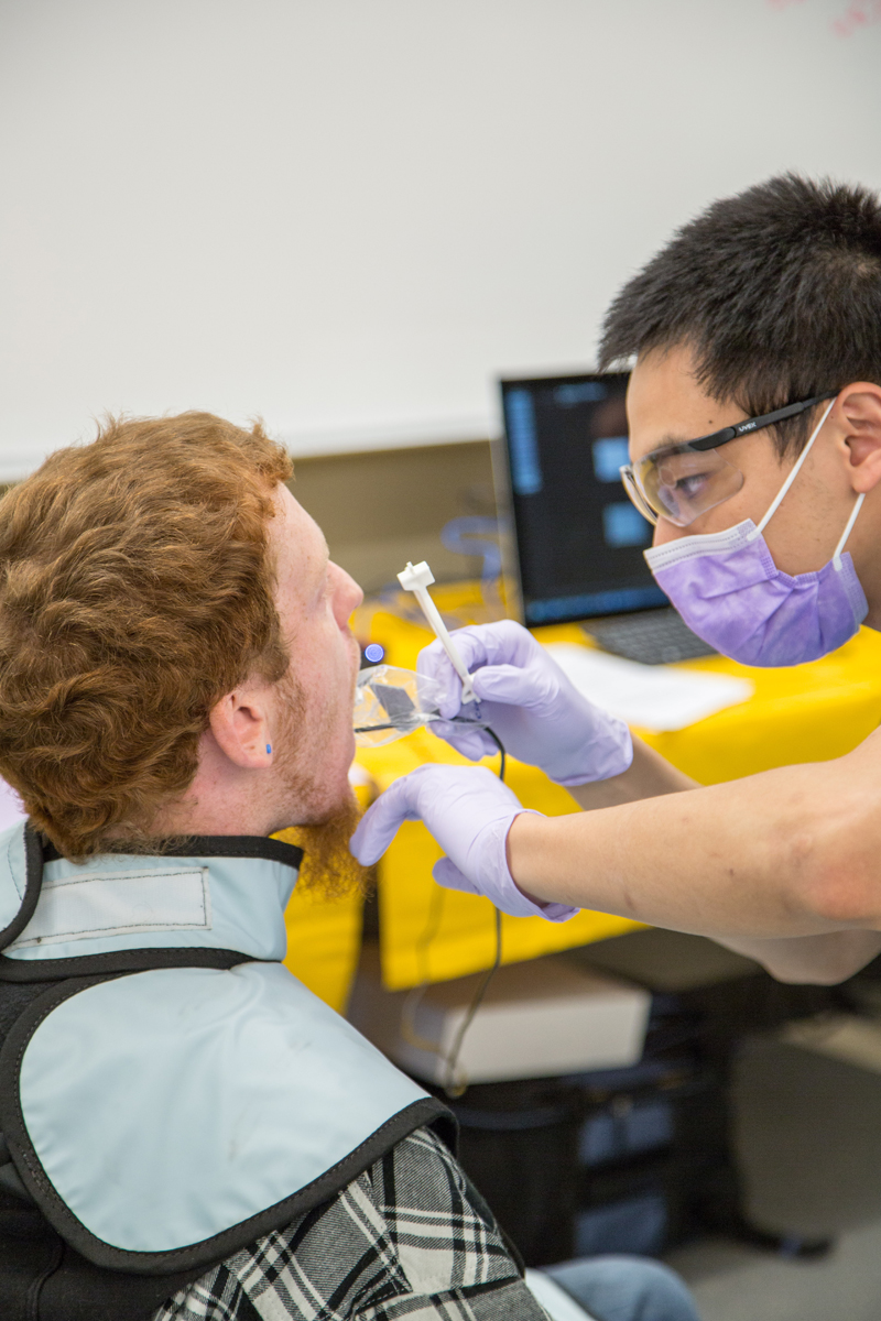 tony-yan-placing-xray-sensor-in-patients-mouth – MEDEX Northwest